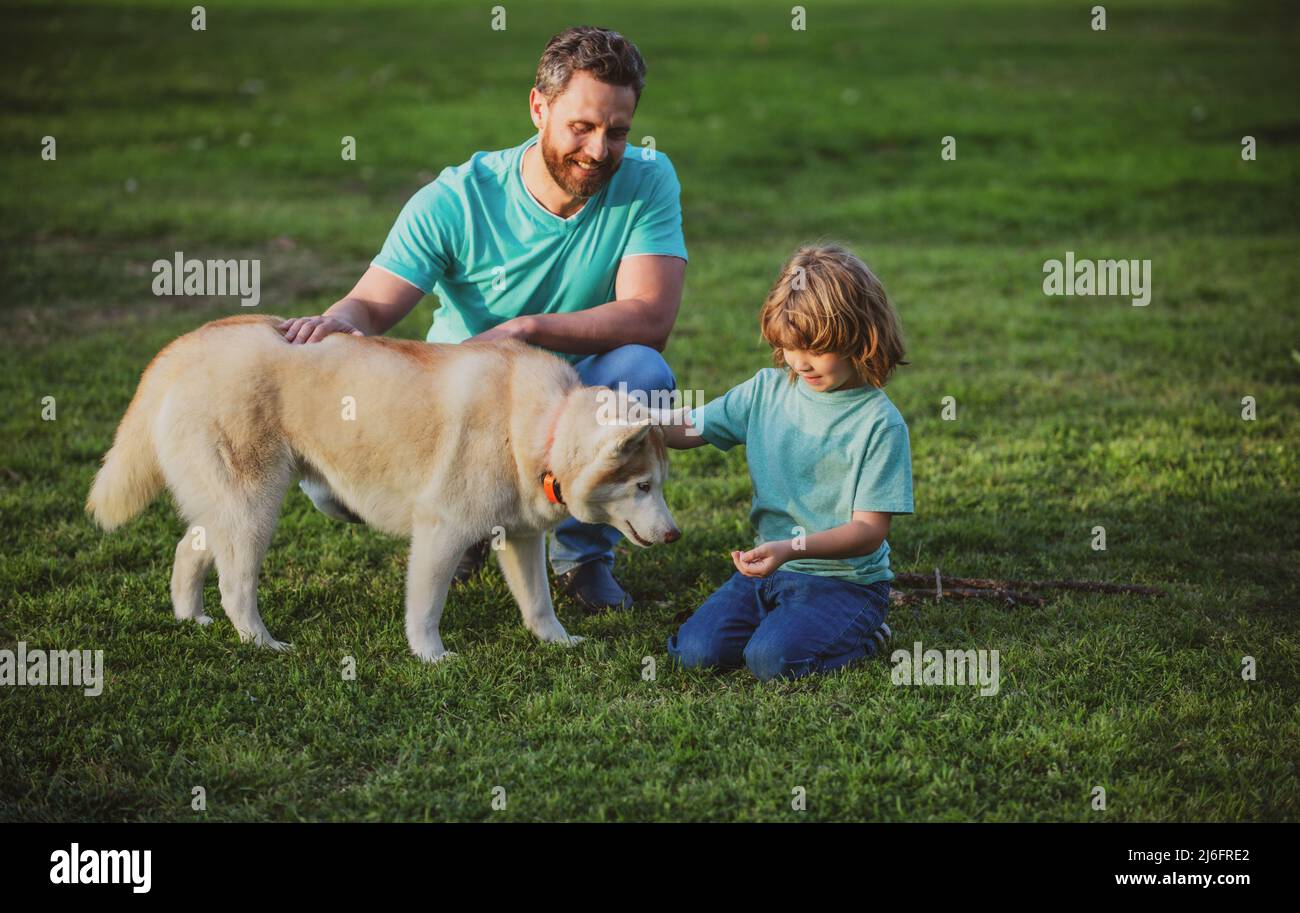 Father and son with pet dog spending time outdoor together Stock Photo ...