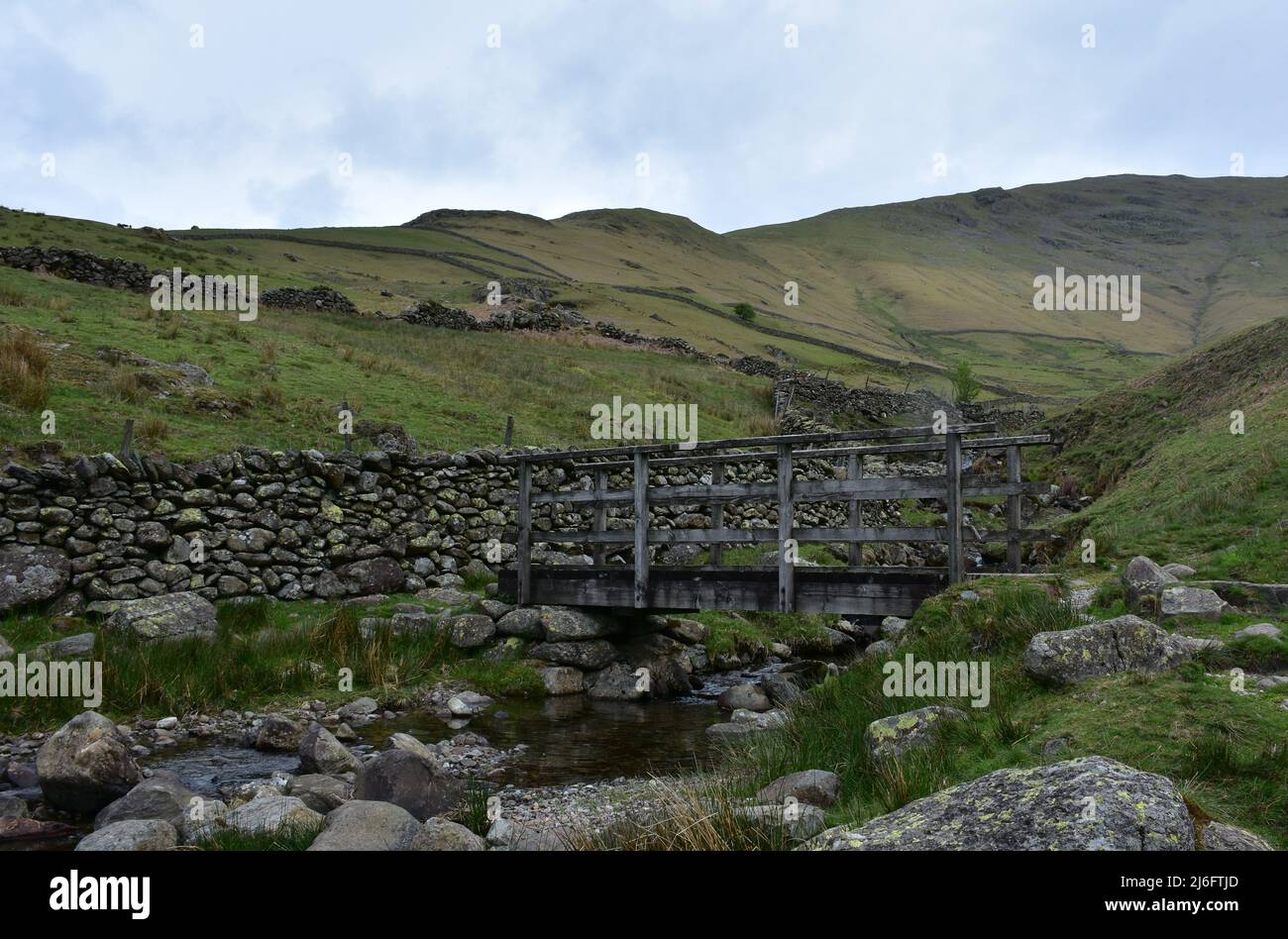 Small brook with a wooden foot bridge connecting hiking trails on both ...