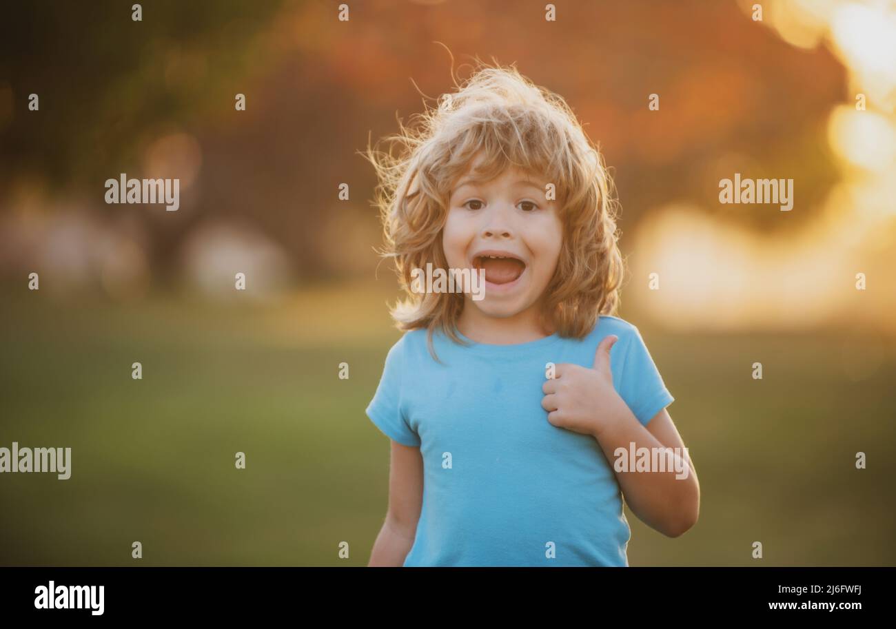 Portrait of a happy laughing child summer outdoor. Close up positive ...