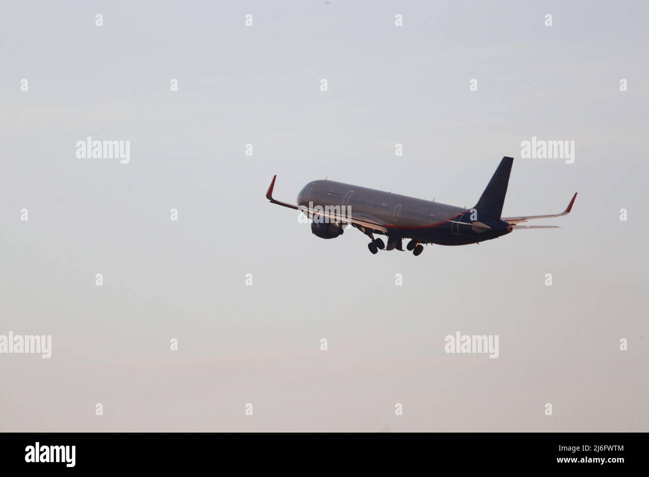 Passenger plane flying against dawning sky. Side-view of aircraft. Side ...