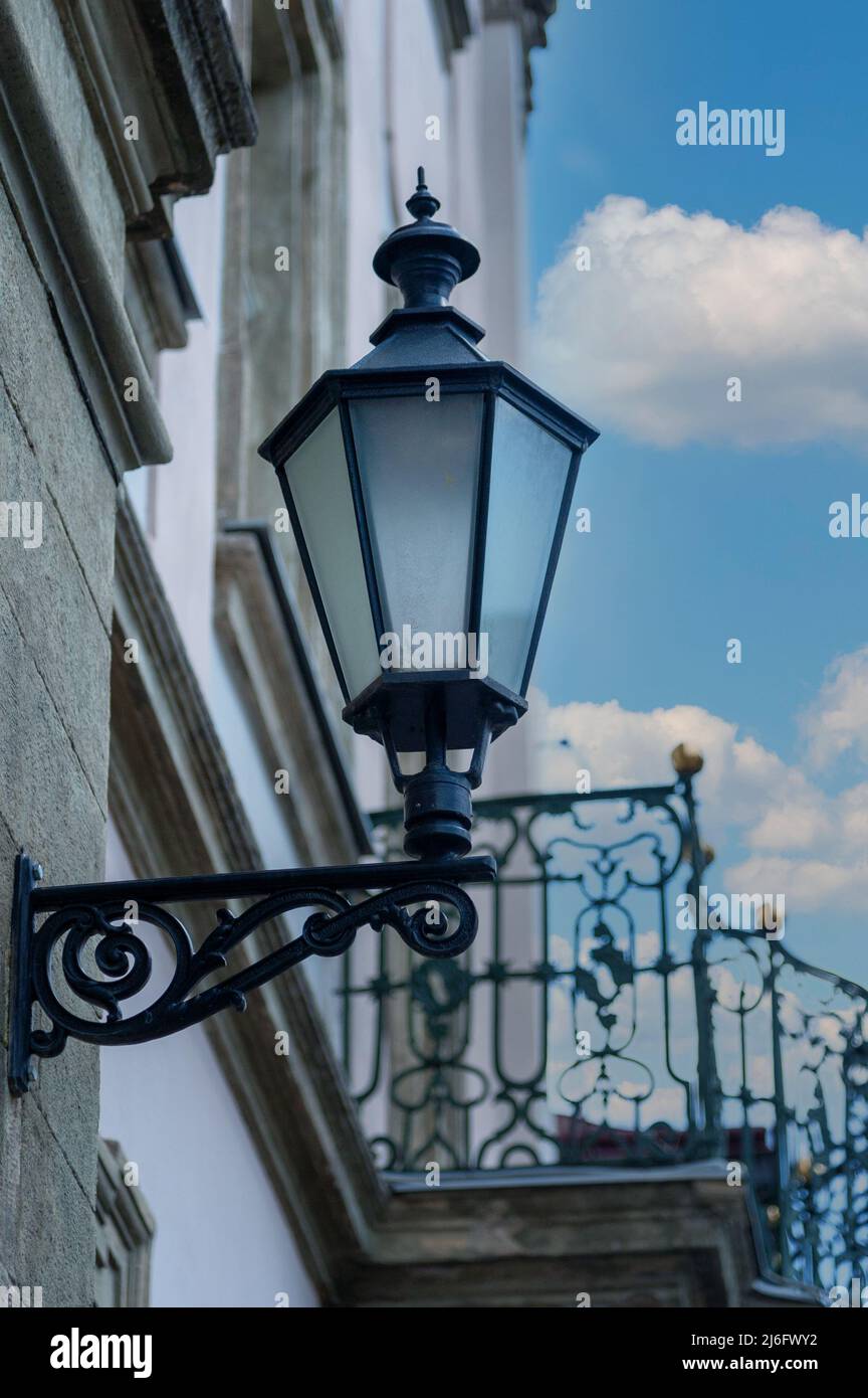 Old street lantern lighting on facade of building. Twilight on city ...