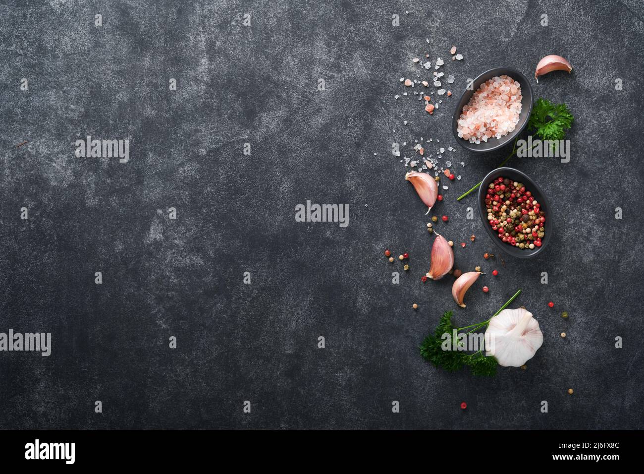 Black food cooking background. Stone texture with sea salt, pepper ...