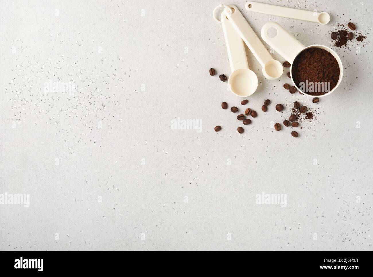 Coffee background. Measuring spoons with ground coffee and beans on old ...
