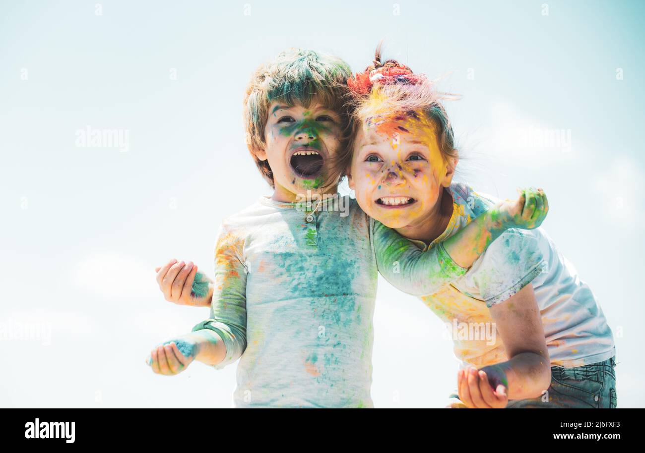 Happy kids playing with colored holi powder. Funny cute preschoolers ...