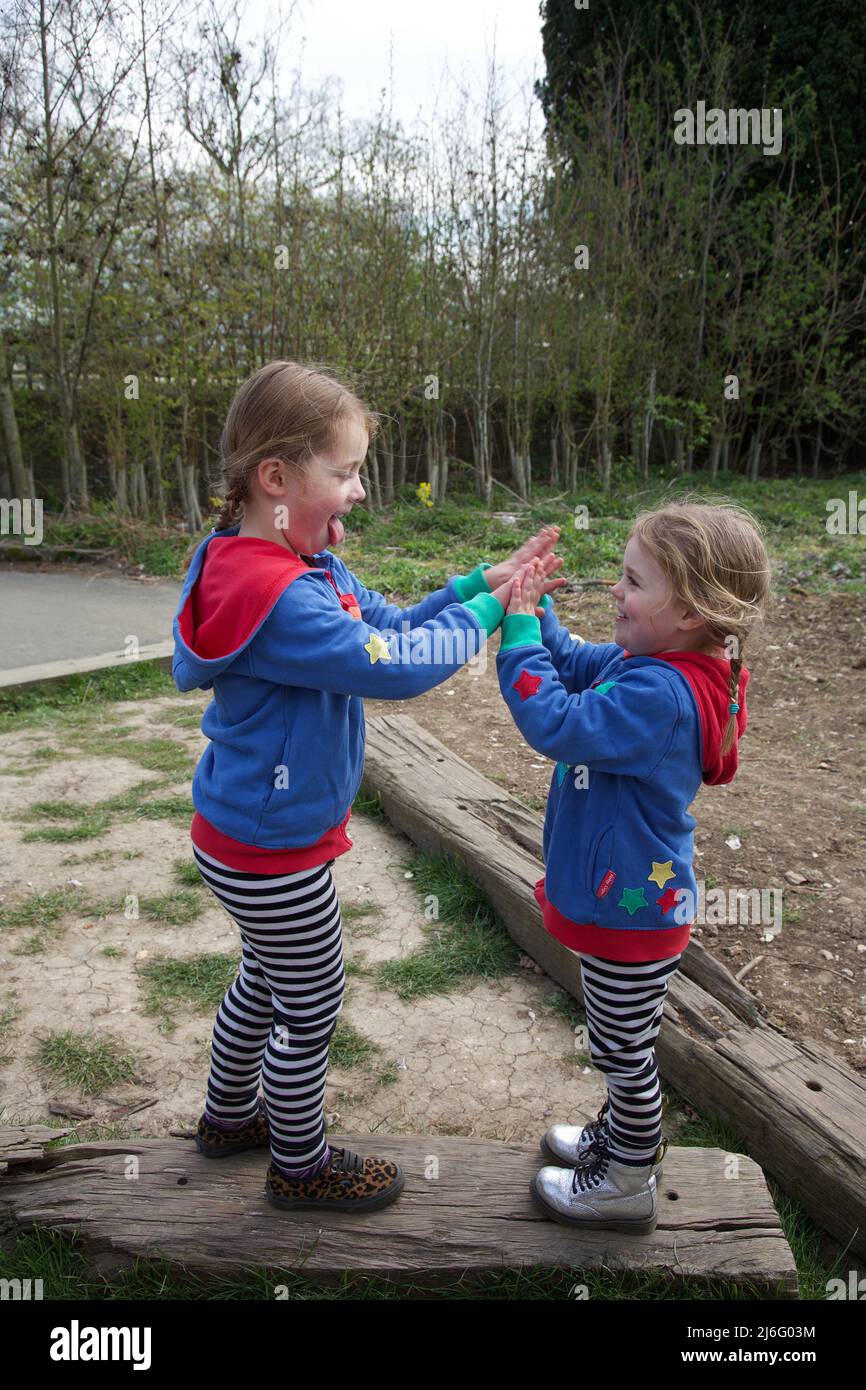 Kids playing Pat a Cake game, UK Stock Photo - Alamy