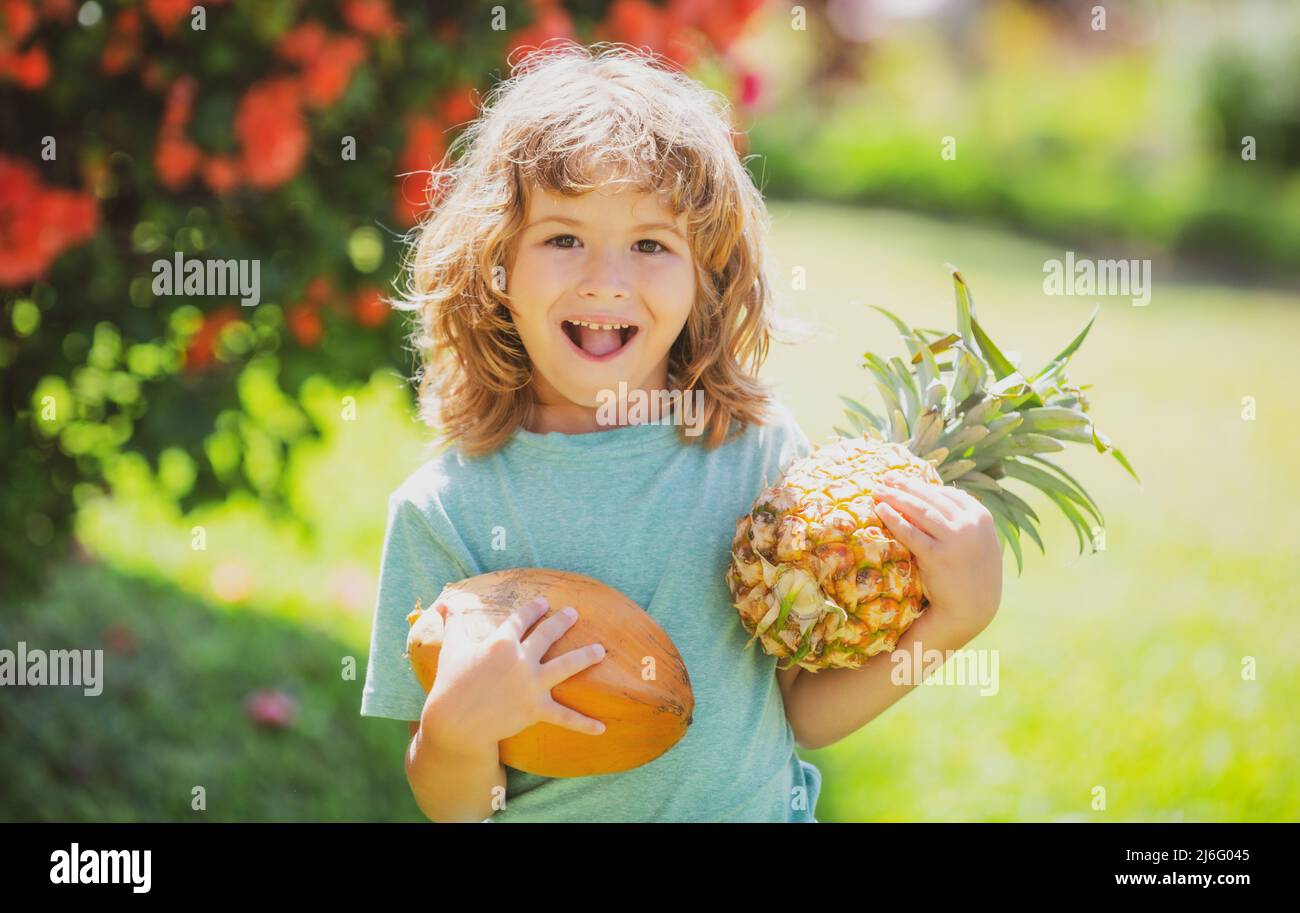 Child with pineapple and coconut. Kids summer vitamin. Tropical fruits ...