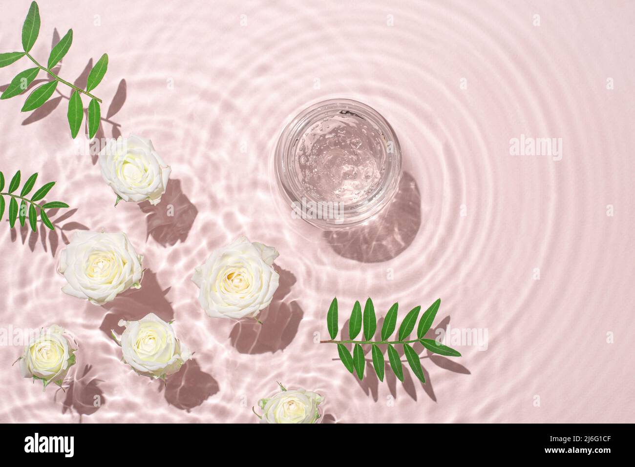 Jar of hydrating gel and flowers Stock Photo - Alamy