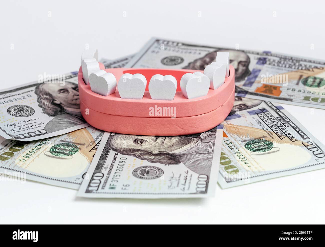 Jaw model with dollar bills. Teeth insurance and cost of tooth ...