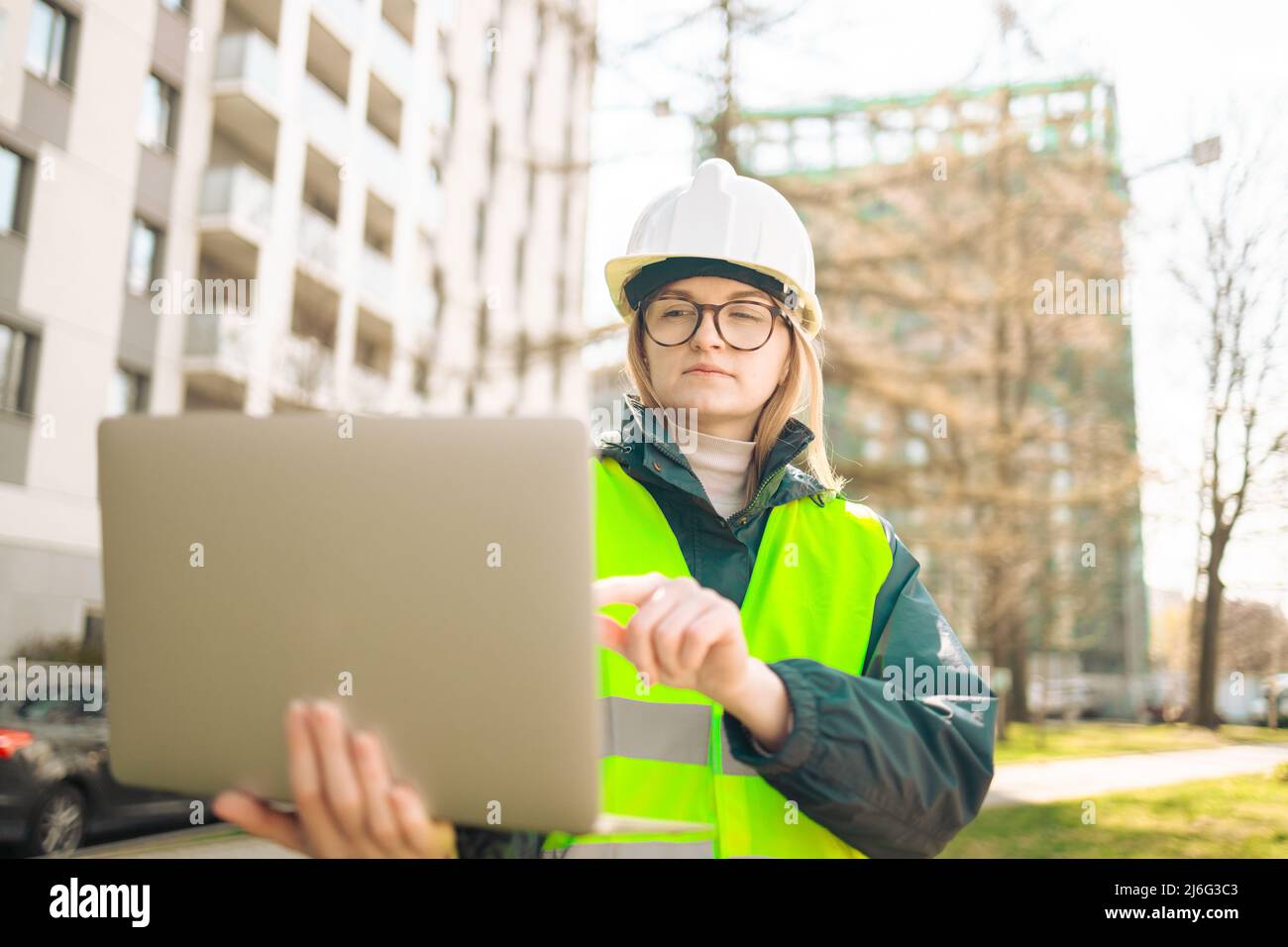 Portrait of engineer beautiful woman worker is standing in white and ...