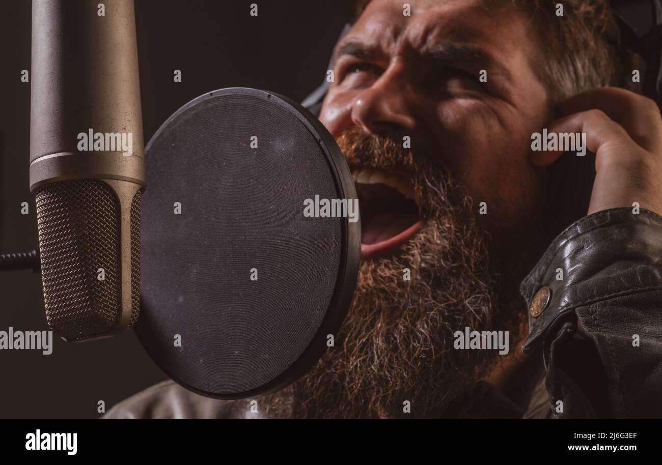 Expressive face closeup. Singer singing rock. Sound producer recording ...