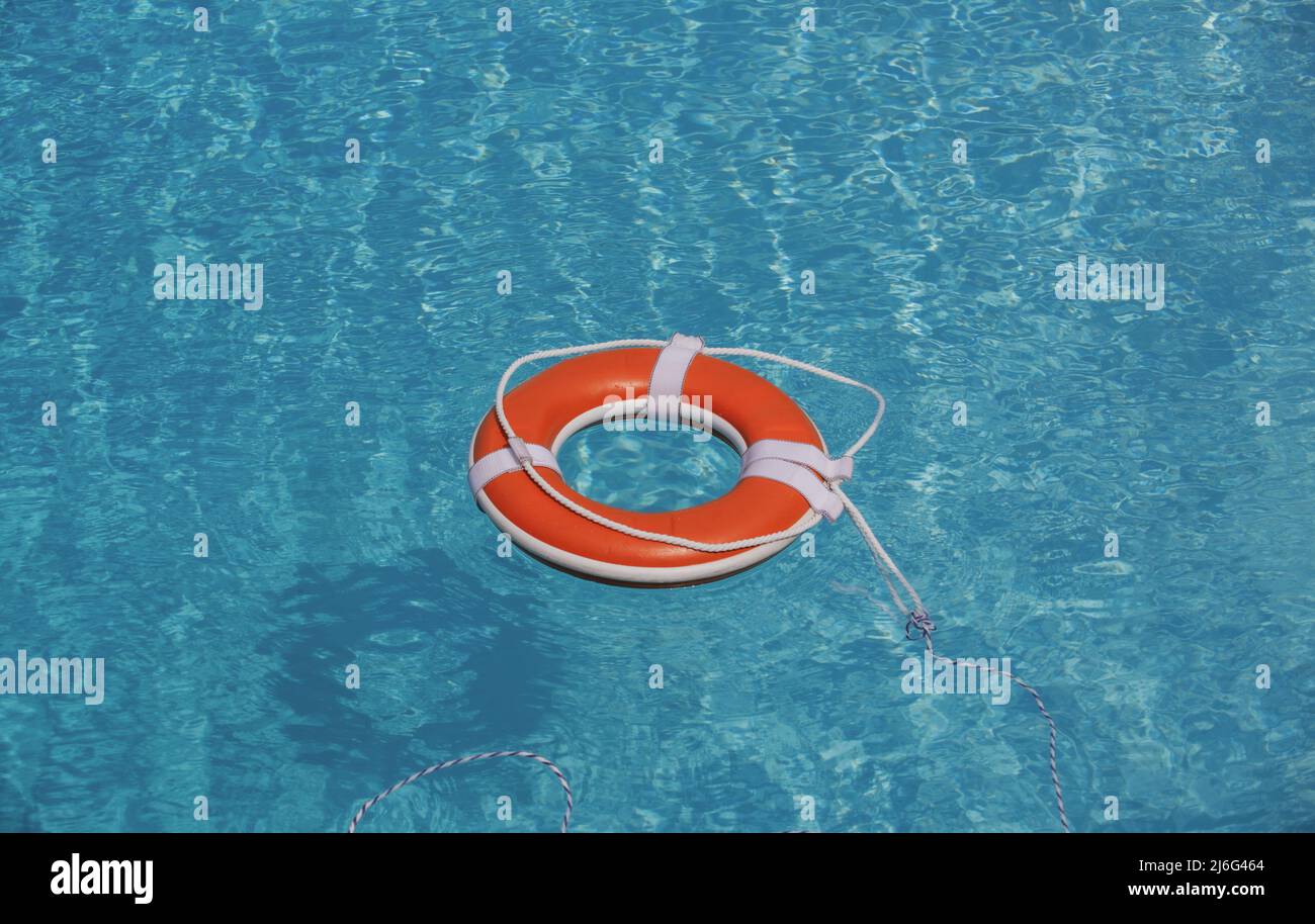 Lifebuoy pool ring float on blue water Stock Photo - Alamy