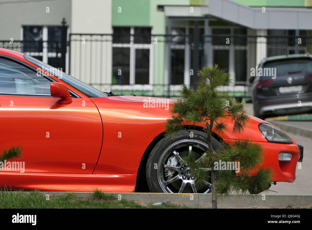 Beautiful red car on the street in the city Stock Photo - Alamy