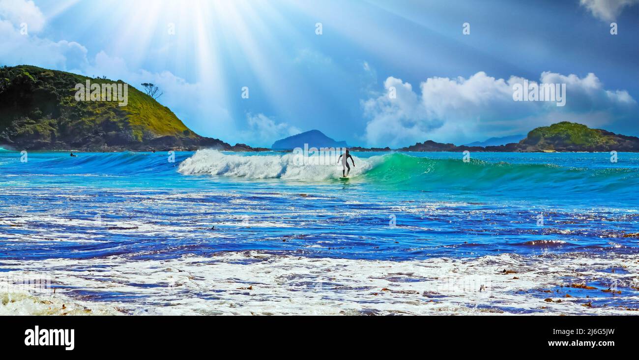Beautiful bay with big waves, unrecognizable one lonely surfer ...