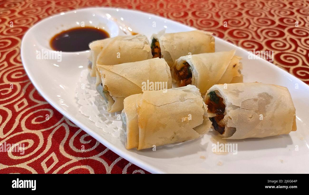 Fried crispy Chinese spring roll on white plate Stock Photo - Alamy
