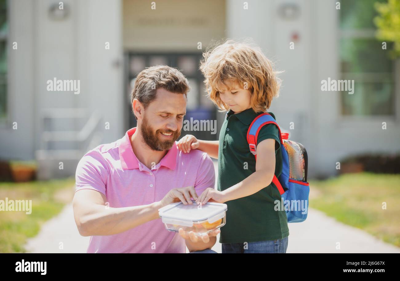 School lunch for kids. Father supports and motivates son. Schoolboy and ...