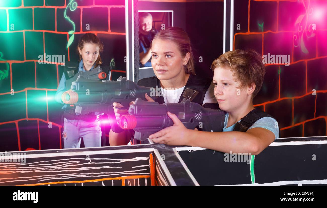 Nice boy and his mother aiming laser guns Stock Photo - Alamy