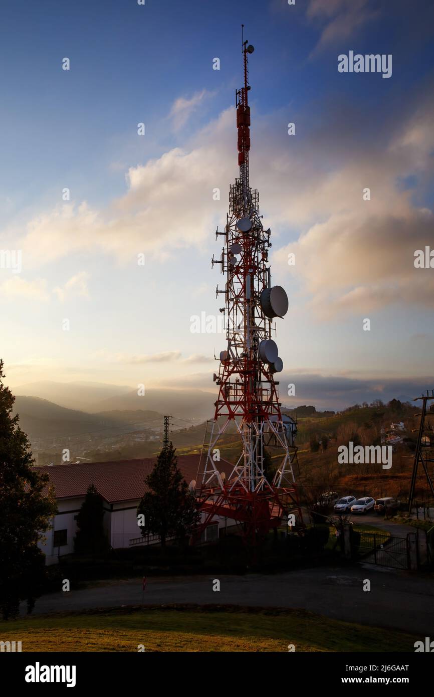 Transmission tower telephone and television tv signals. Red-white ...