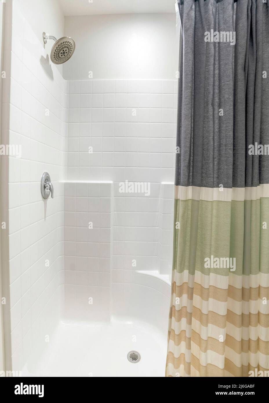 Vertical Shower stall of a bathroom with a tile pattern wall panel ...