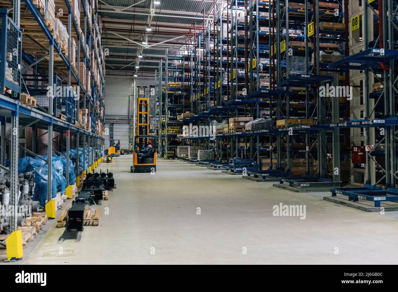 Forklift loader in Modern warehouse interior with shelves and boxes ...