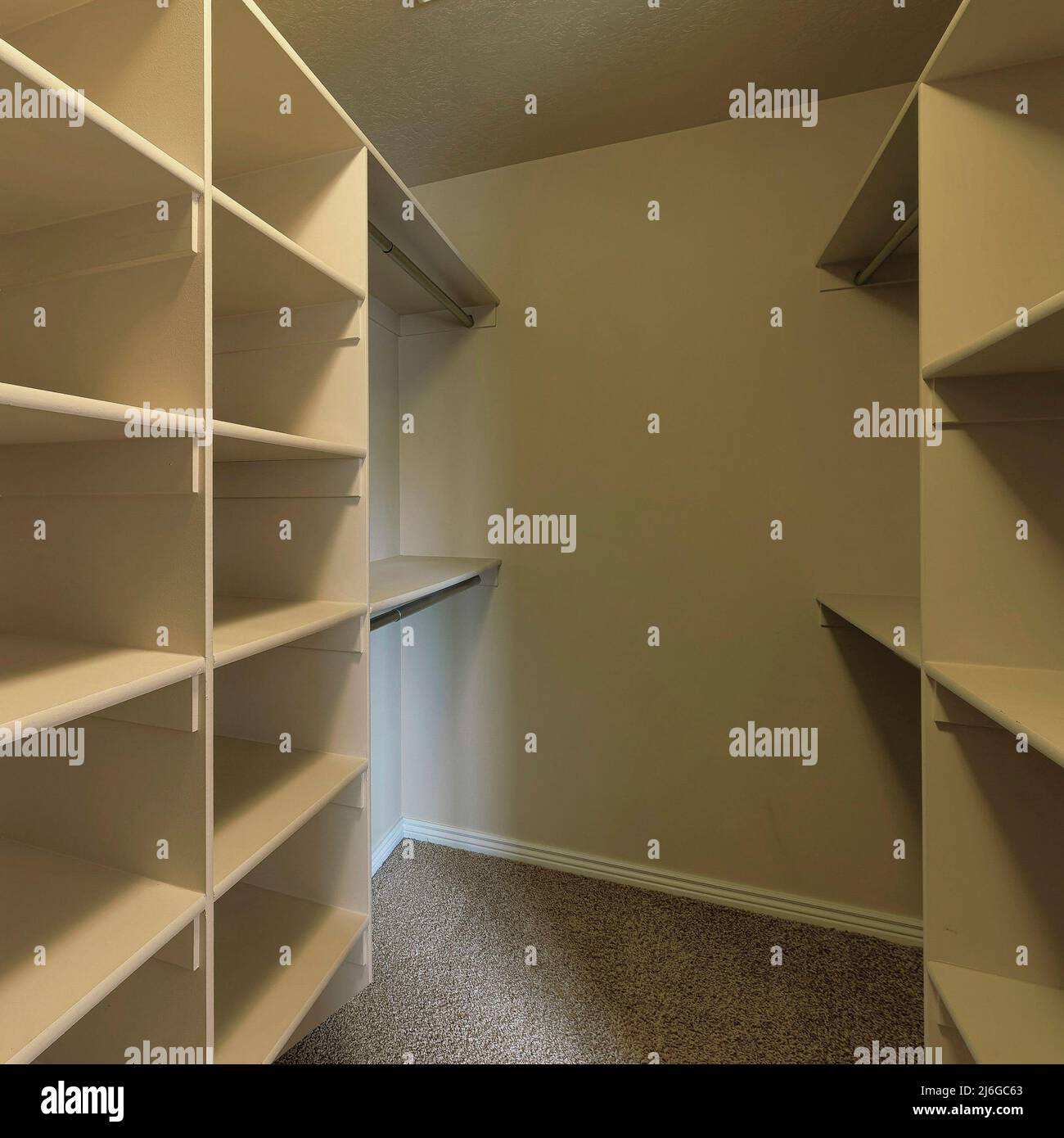 Square Empty walk-in closet with framed shelves and metal rods Stock ...