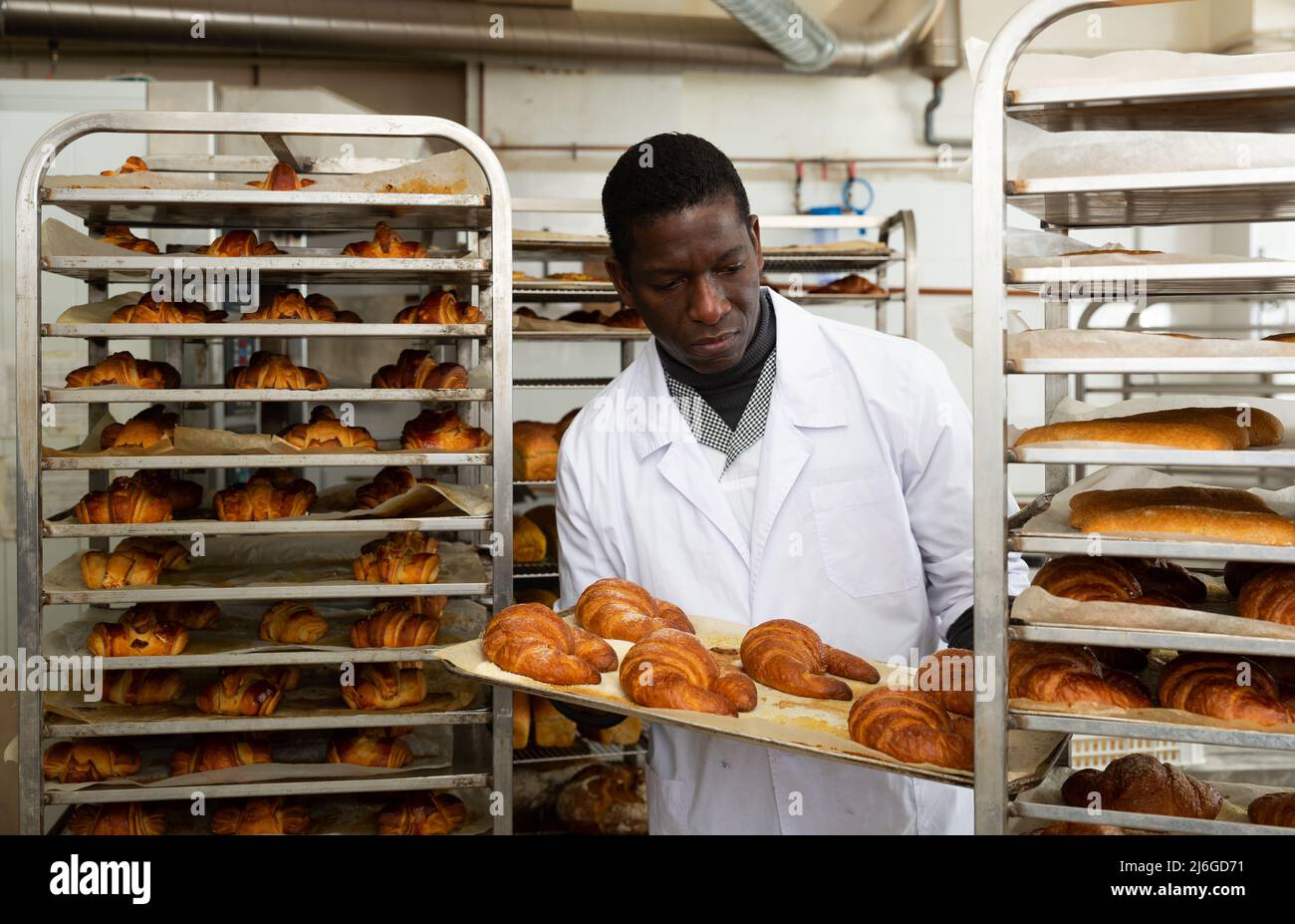 African-american lay out over trolley fresh pastries Stock Photo - Alamy