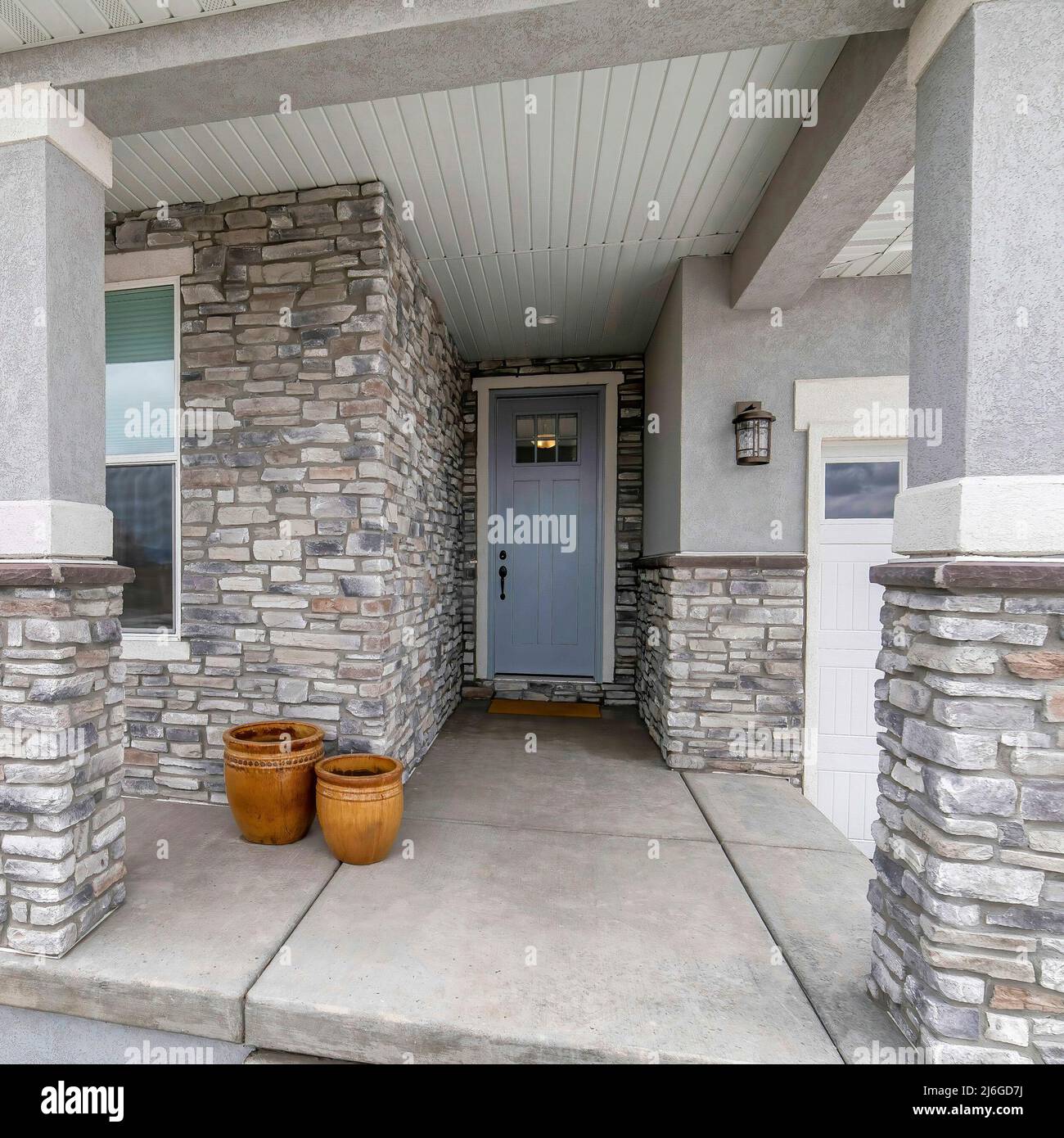 Square House exterior with stone veneer siding and garage Stock Photo ...