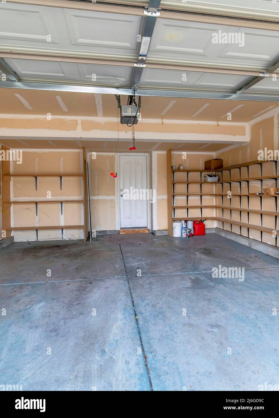 Vertical Interior of garage with a white line markings, wooden shelves ...