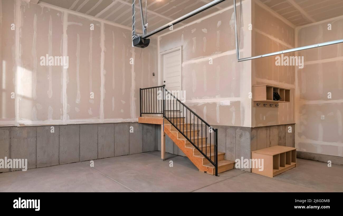 Panorama Interior of an unfinished garage with staircase leading to the ...
