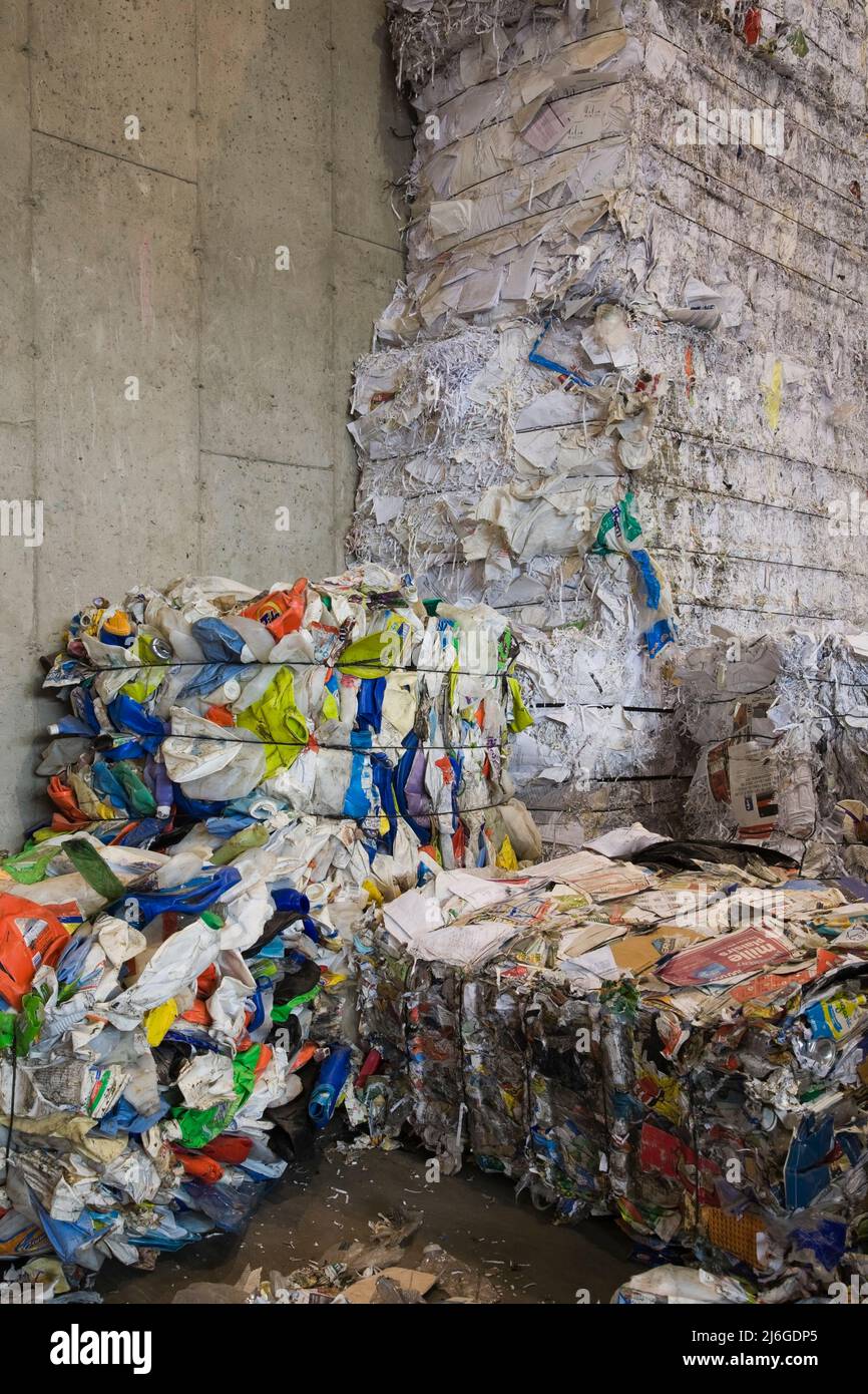 Bales of recyclable plastic containers and paper at sorting centre ...