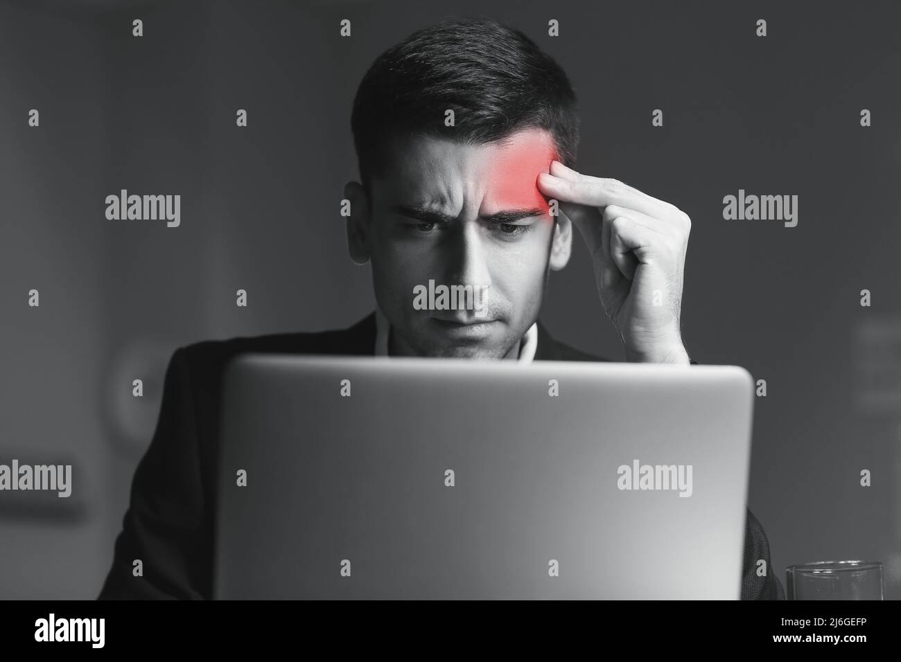 Young businesswoman feeling headache while working on laptop in office ...