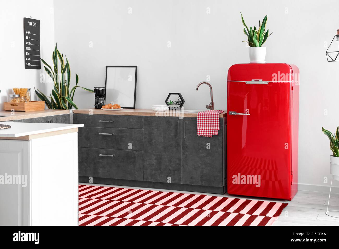 Interior of modern kitchen with red fridge and carpet Stock Photo - Alamy
