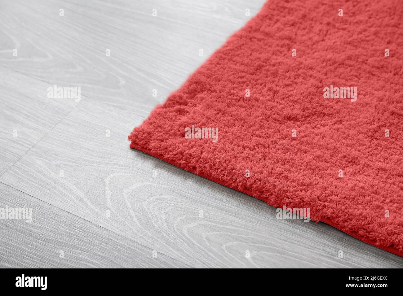 Red carpet on wooden floor in room Stock Photo - Alamy