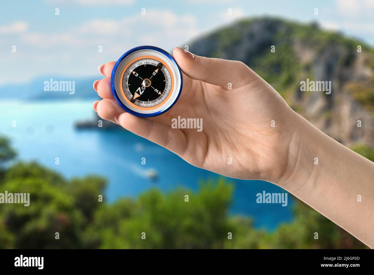 Hand of female tourist with compass at resort, closeup Stock Photo - Alamy