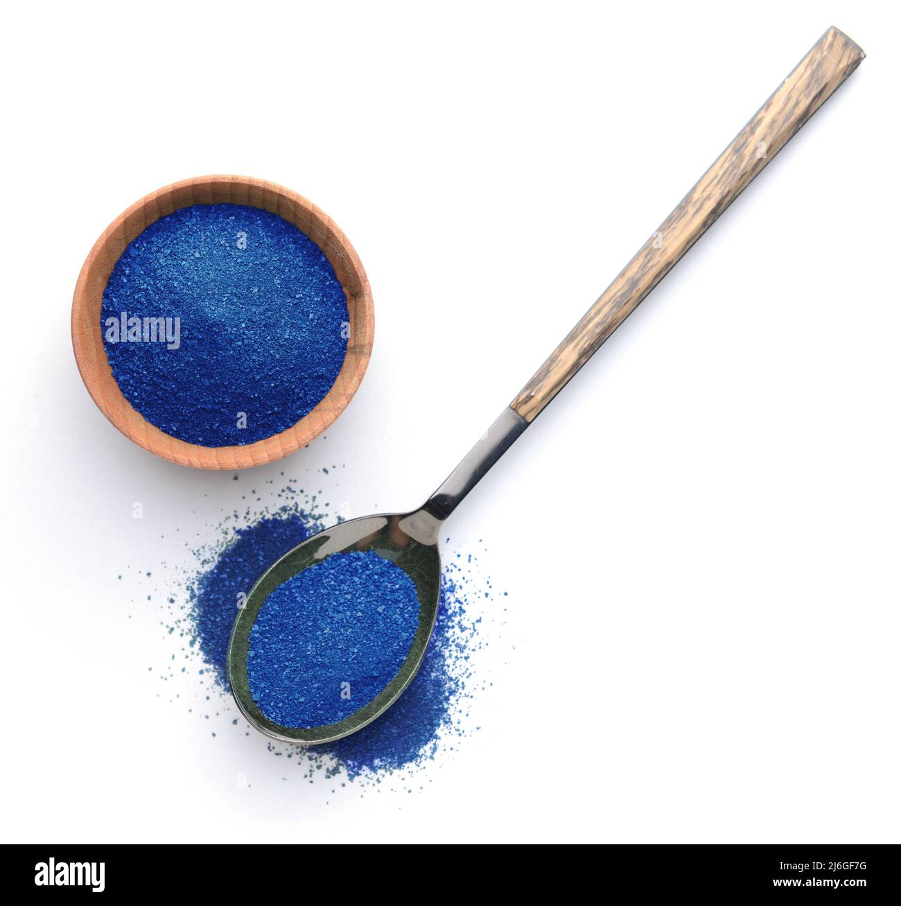 Bowl and spoon with blue spirulina powder on white background Stock ...