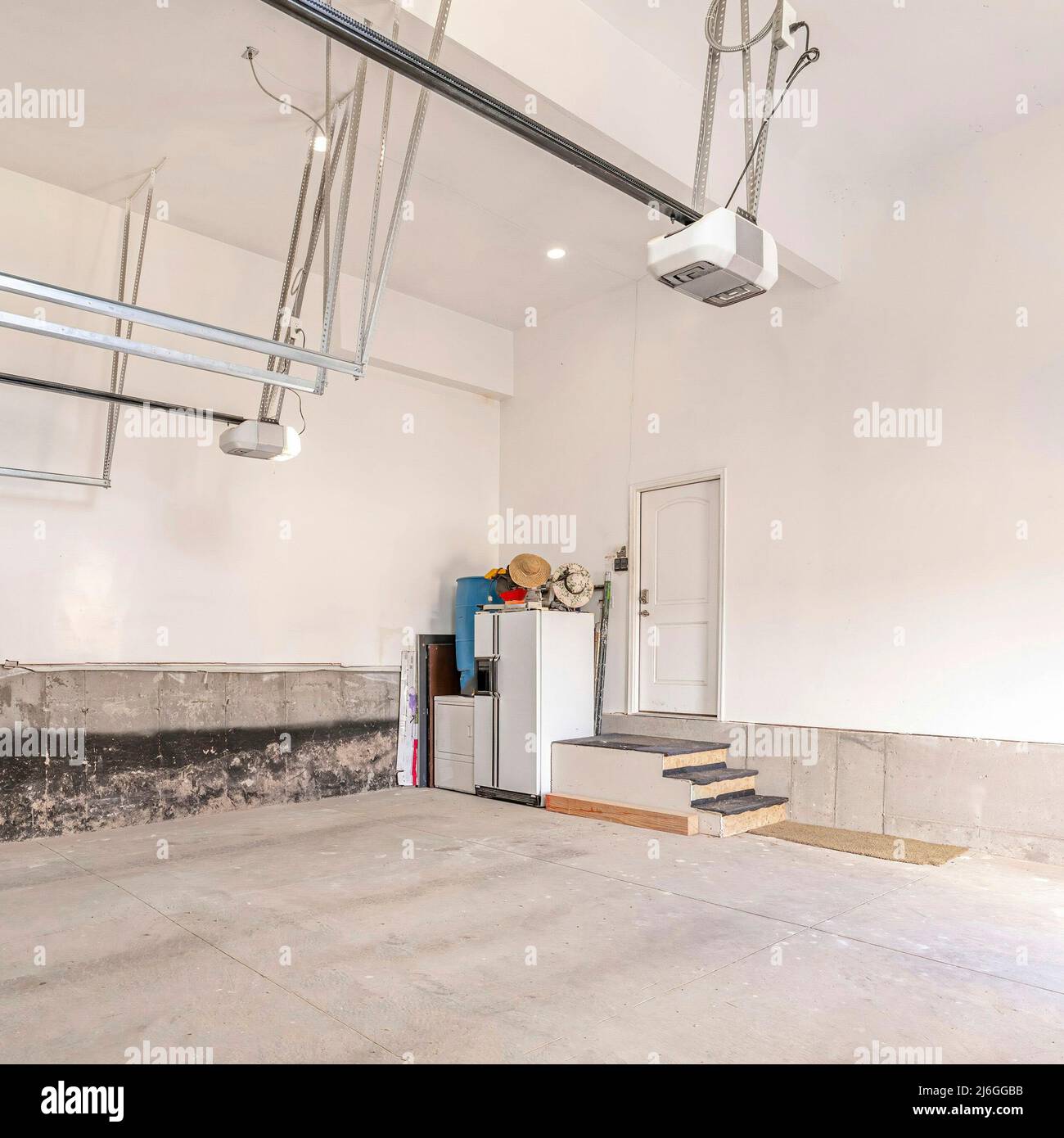 Square Large concrete garage exterior with automatic door operators ...