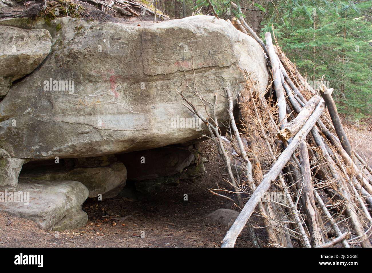 Lean-to Wood Shelter on Overhanging Rock Cave Stock Photo - Alamy