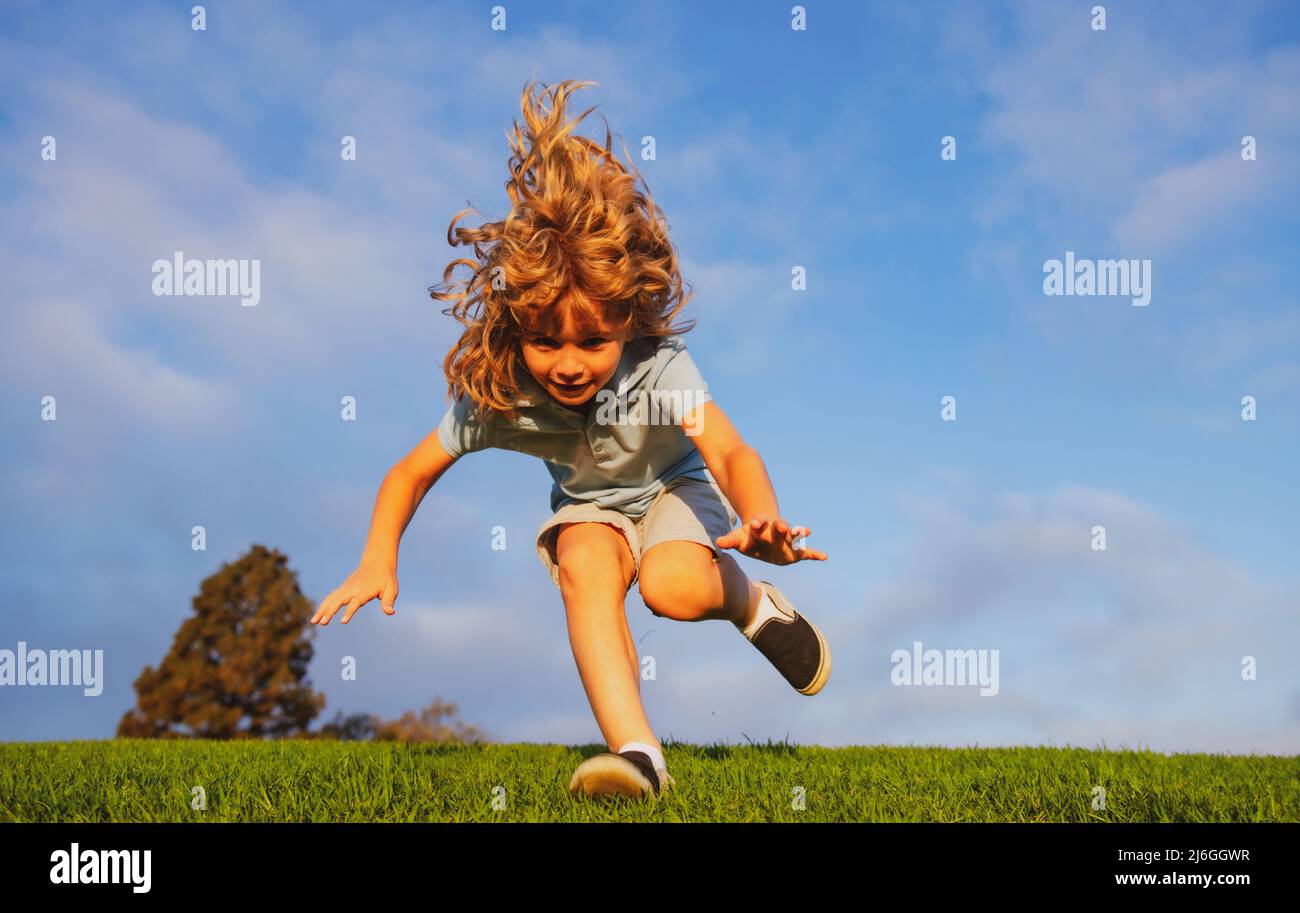 Boy falling down on grass. Kid falling off at the park. Child insurance ...