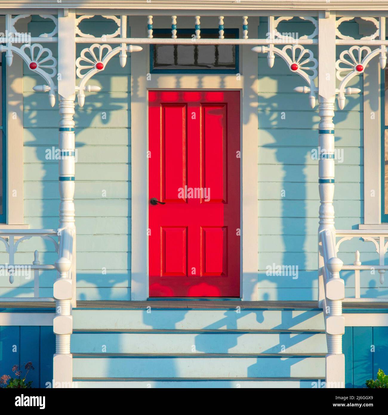 Square Front porch exterior with red front door at Oceanside ...