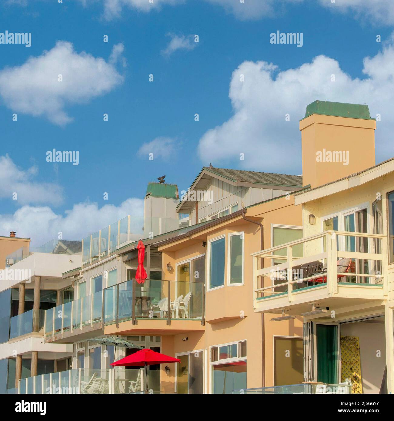 Square White puffy clouds Row of building accommodations at Oceanside ...