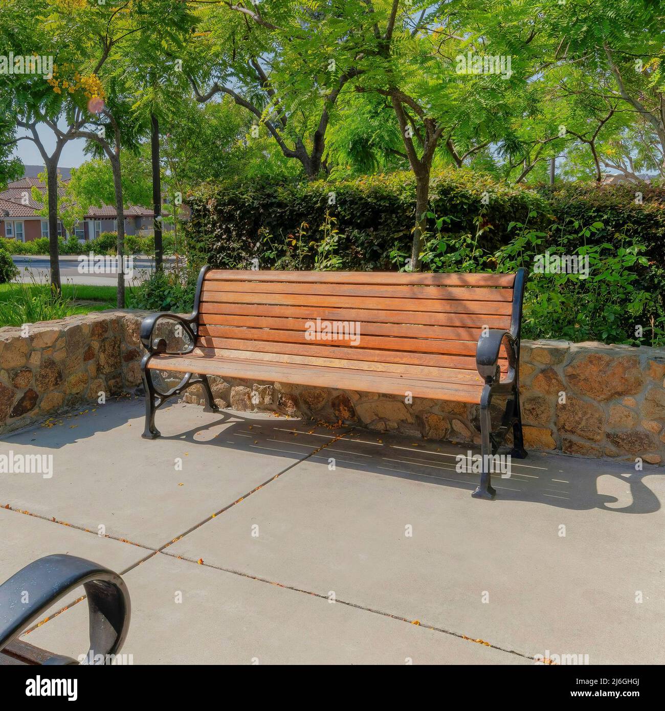 Square White puffy clouds Two benches in a small residential park at ...