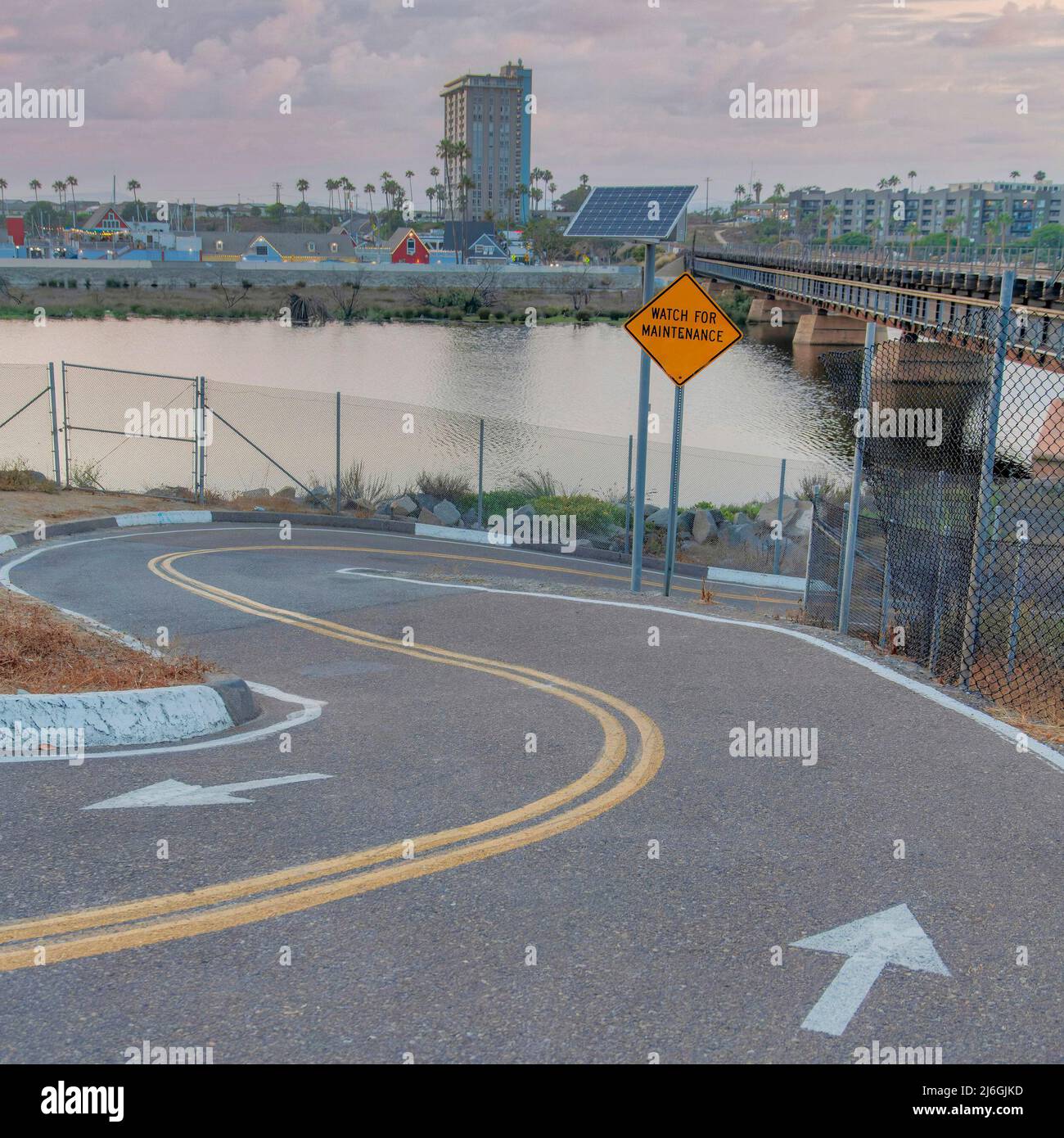 Square Puffy clouds at sunset Two-way curved downhill bike path at ...