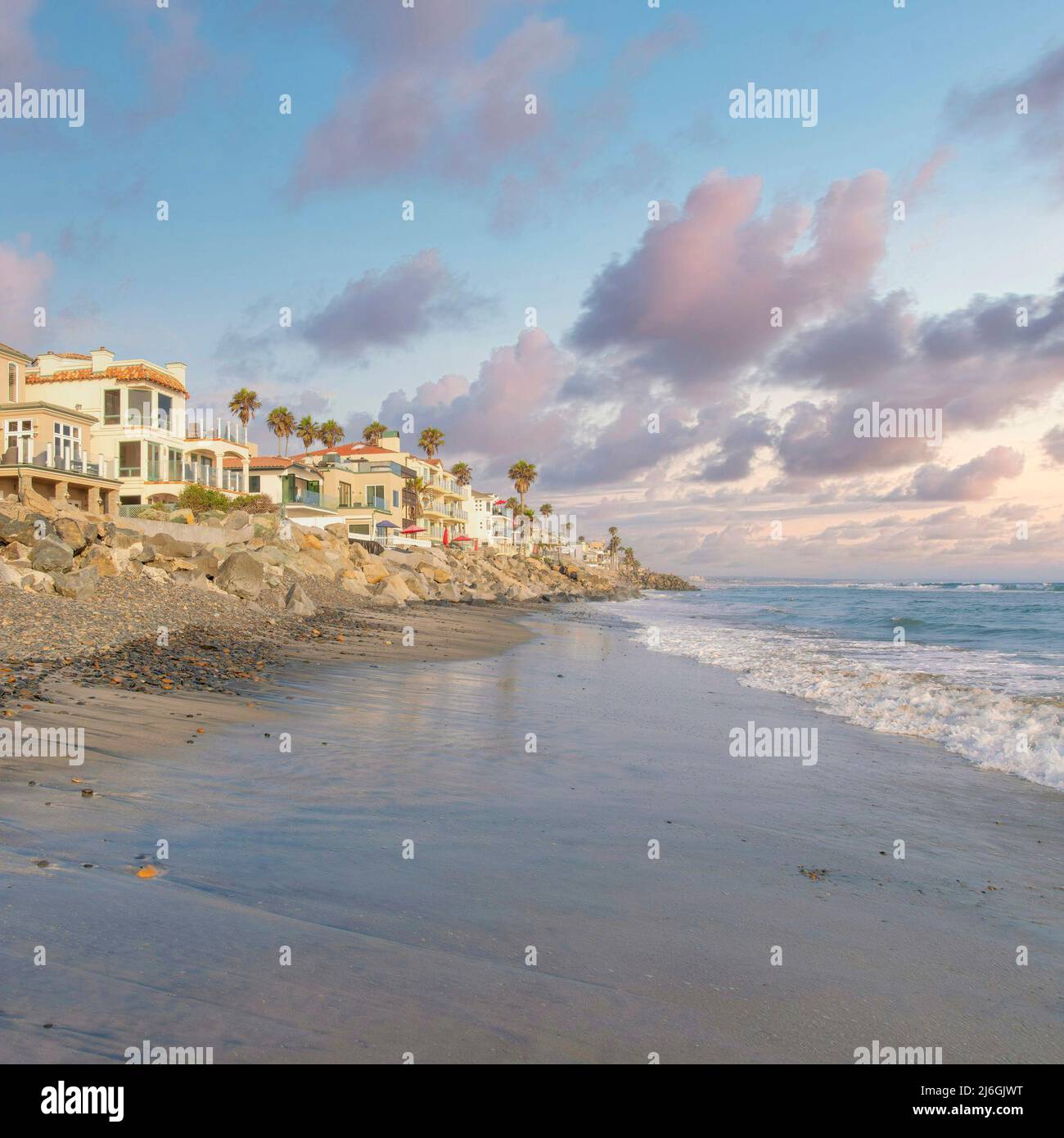 Square Puffy clouds at sunset Huge buildings with beach waterfront in ...