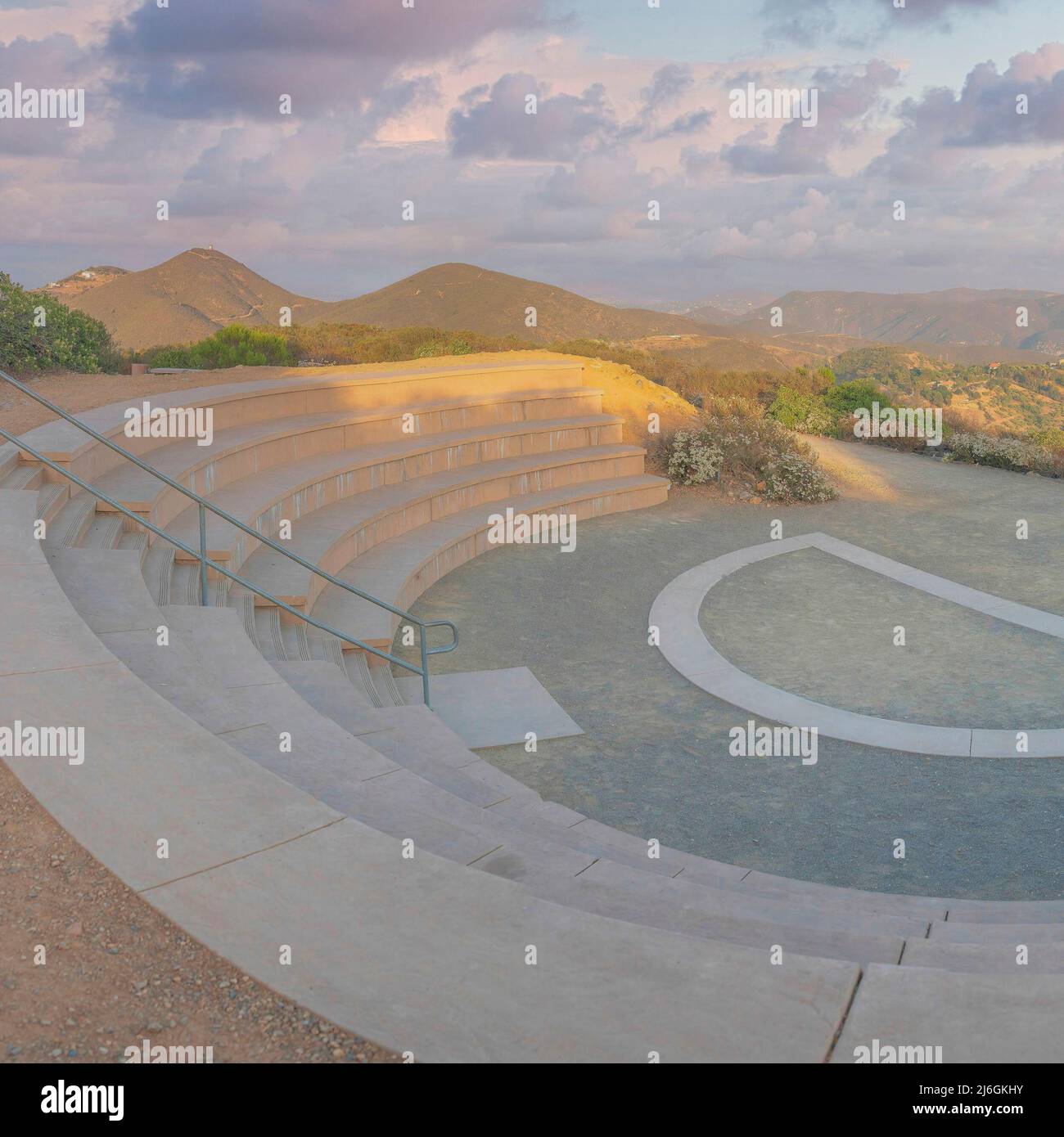 Square Puffy clouds at sunset Small half amphitheatre near the edge of ...