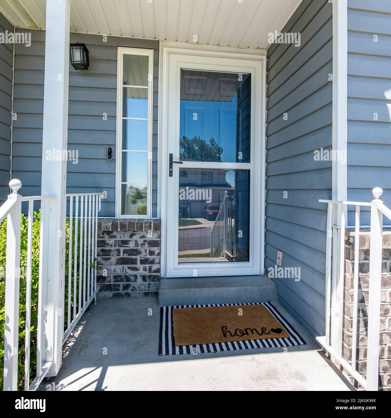 Square Front porch of a house with glass storm door with sidelight ...