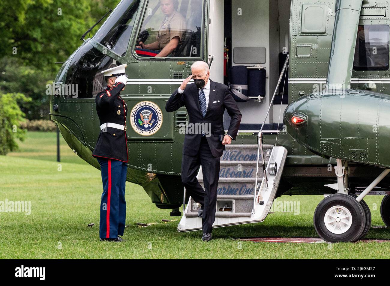 President Joe Biden saluting the Marine after returning to the White ...