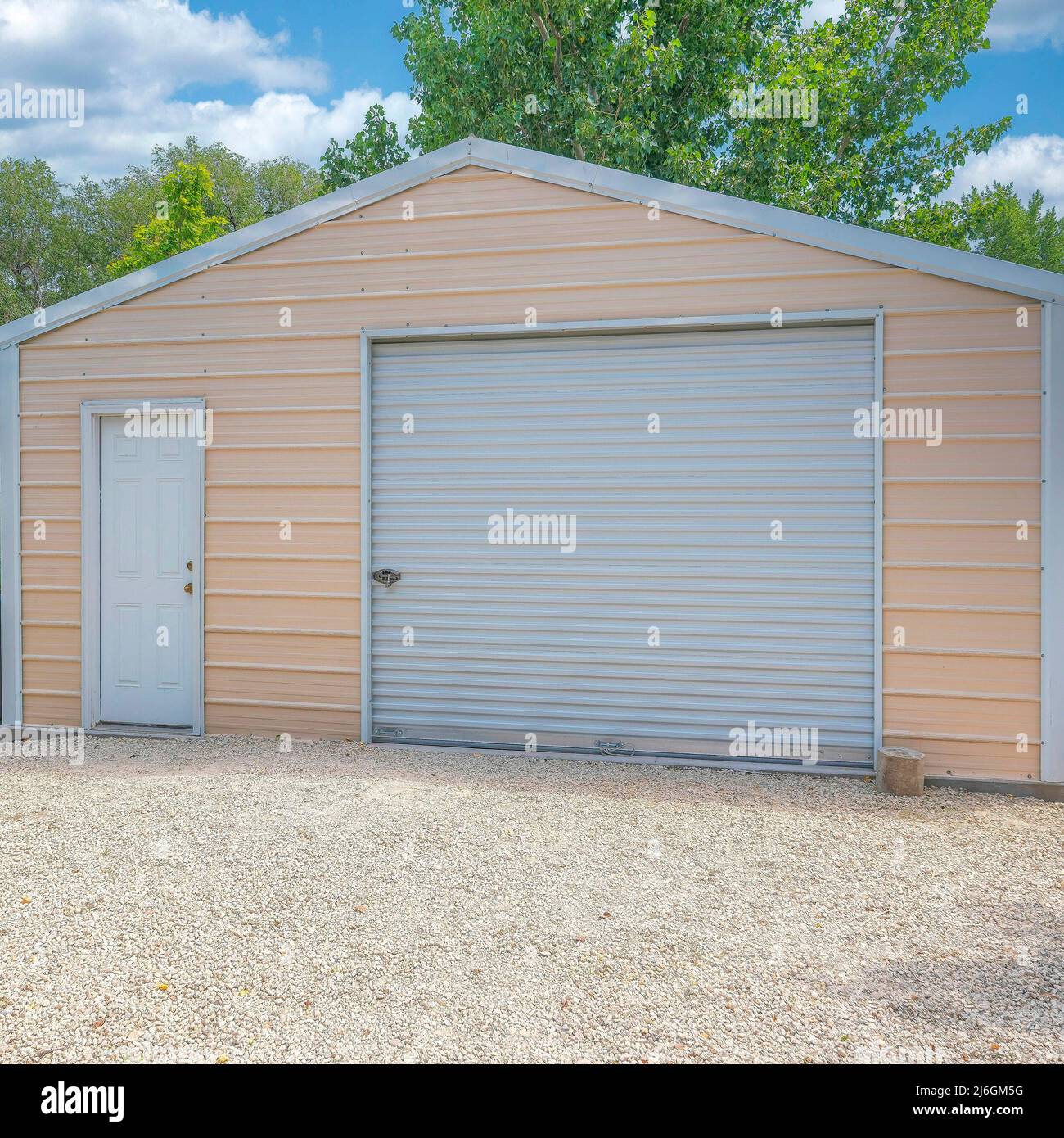 Square White puffy clouds Detached gable garage exterior with steel ...