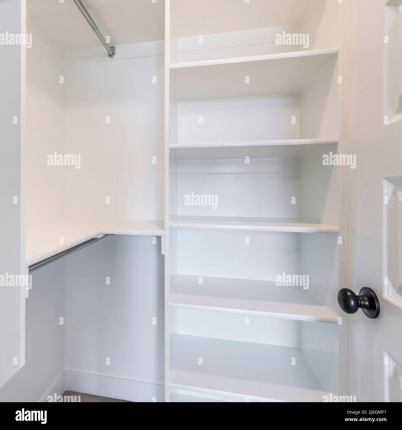 Square Small walk in closet with white interior and carpeted flooring ...