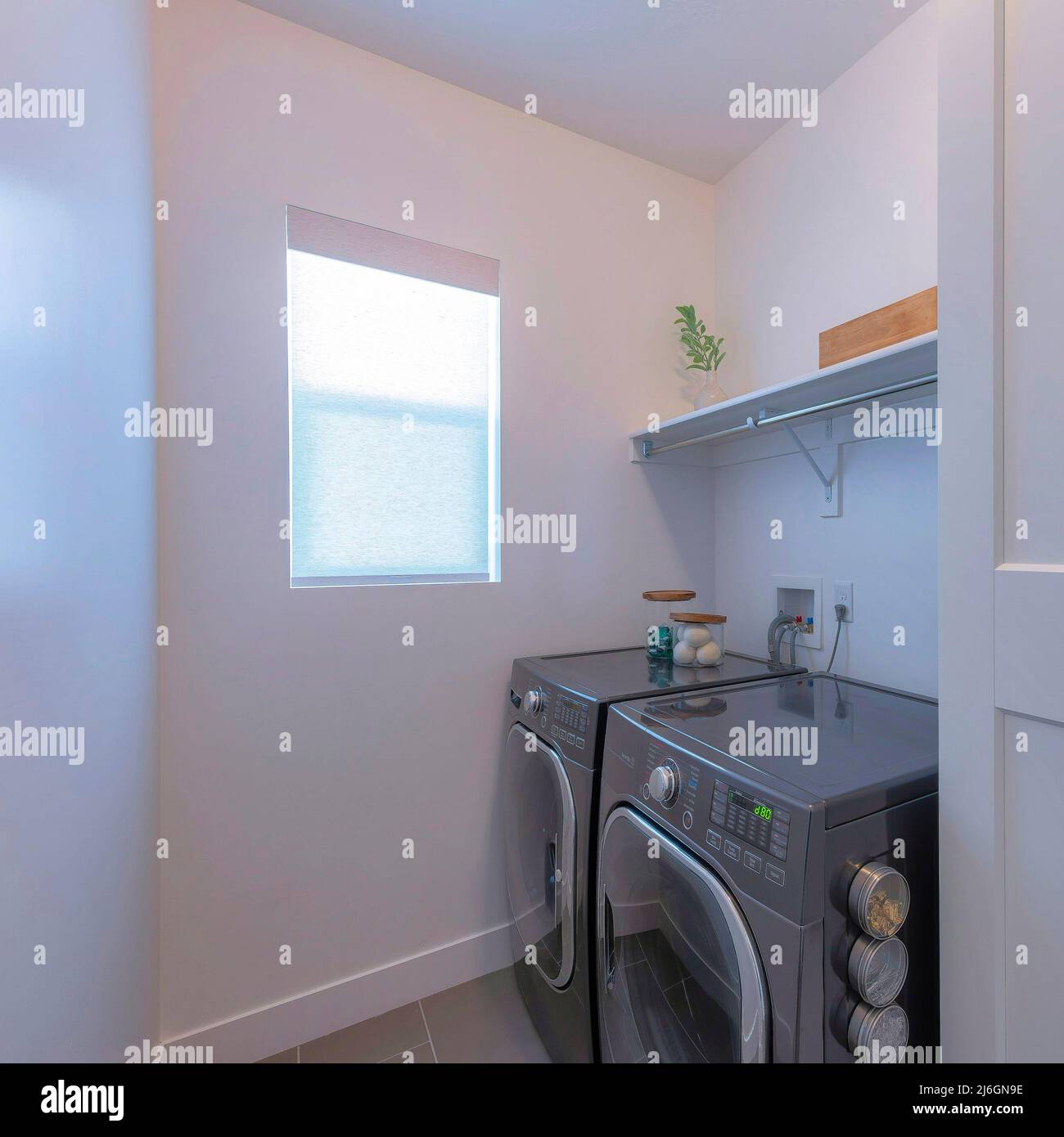 Square Laundry room with white interior and window with linen shade ...