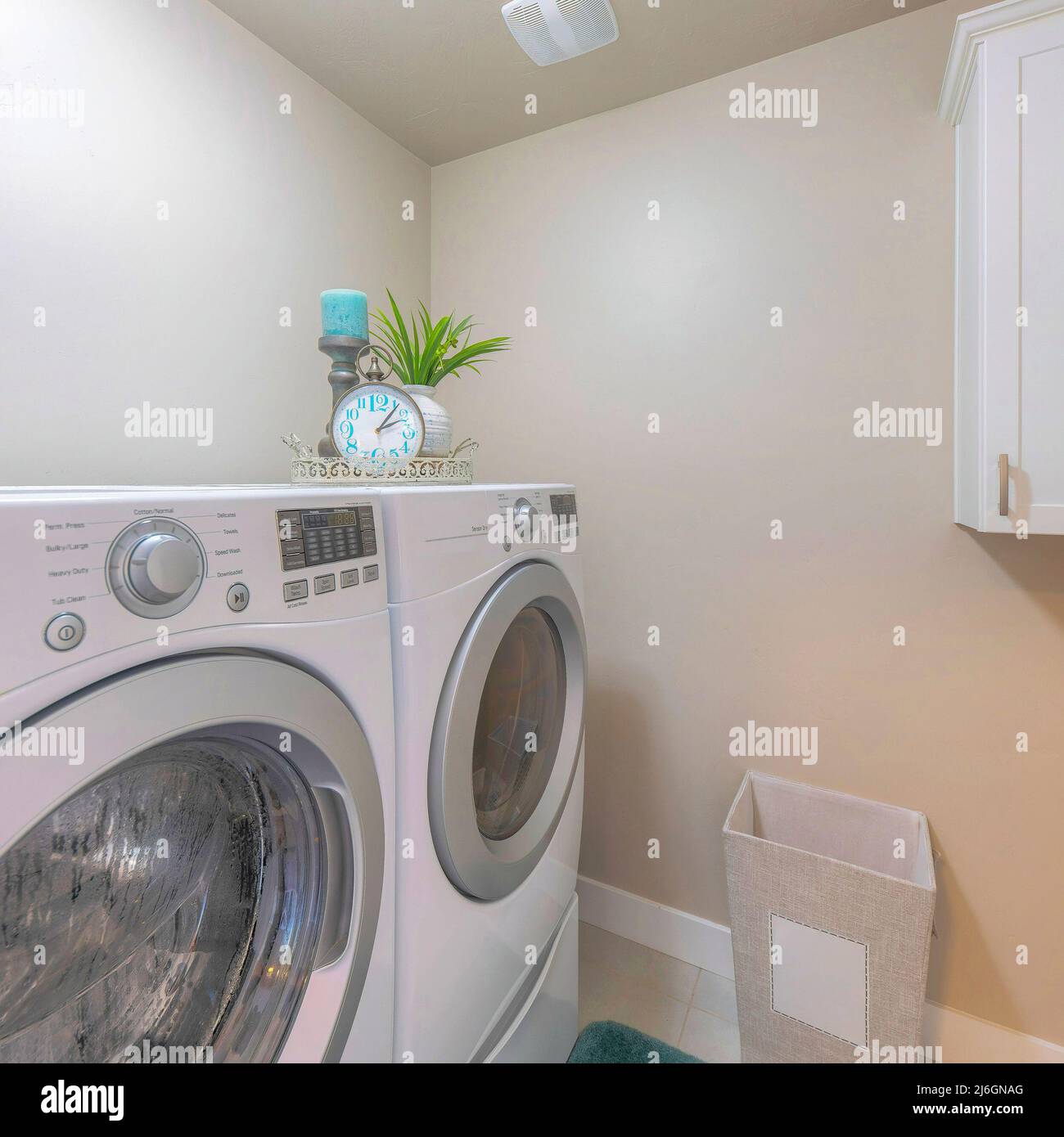 Square Laundry room interior with corner wall cabinet and linen laundry ...