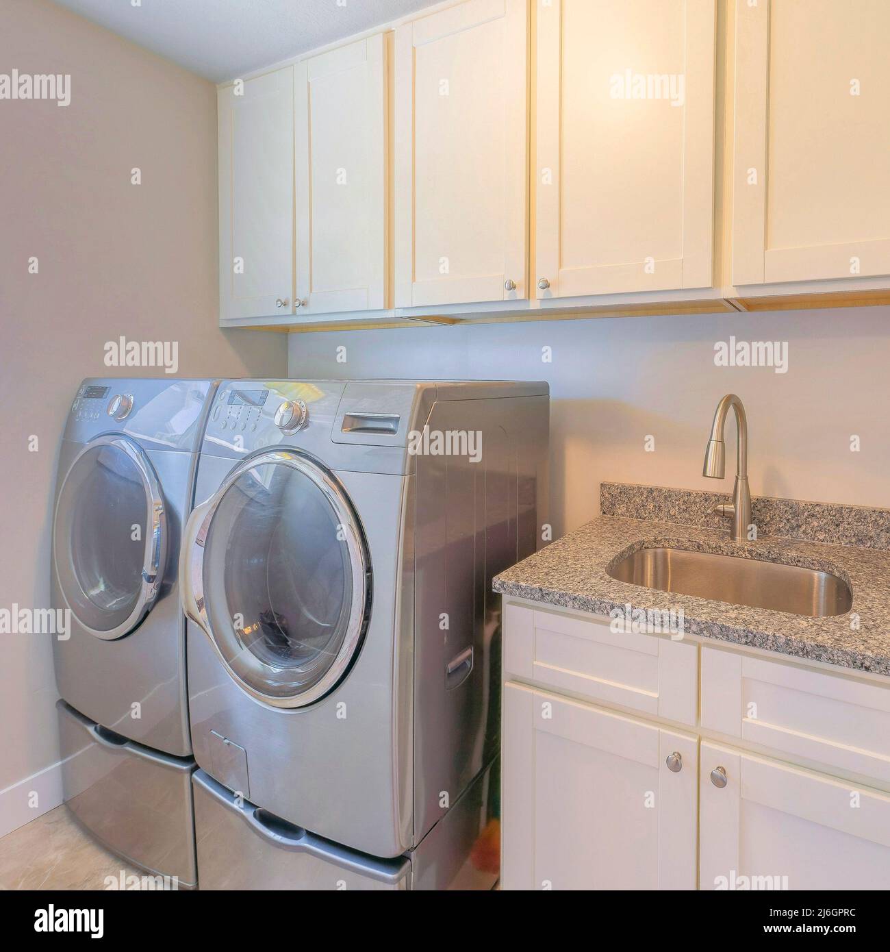 Square Laundry interior with front load laundry units and vanity sink ...
